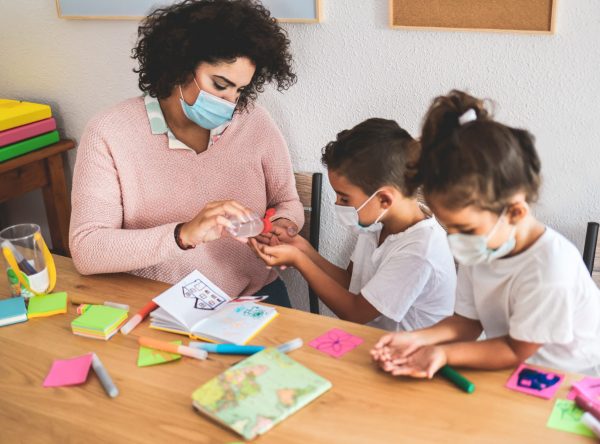 Teacher disinfect students hands with sanitizer gel – Back to school ...